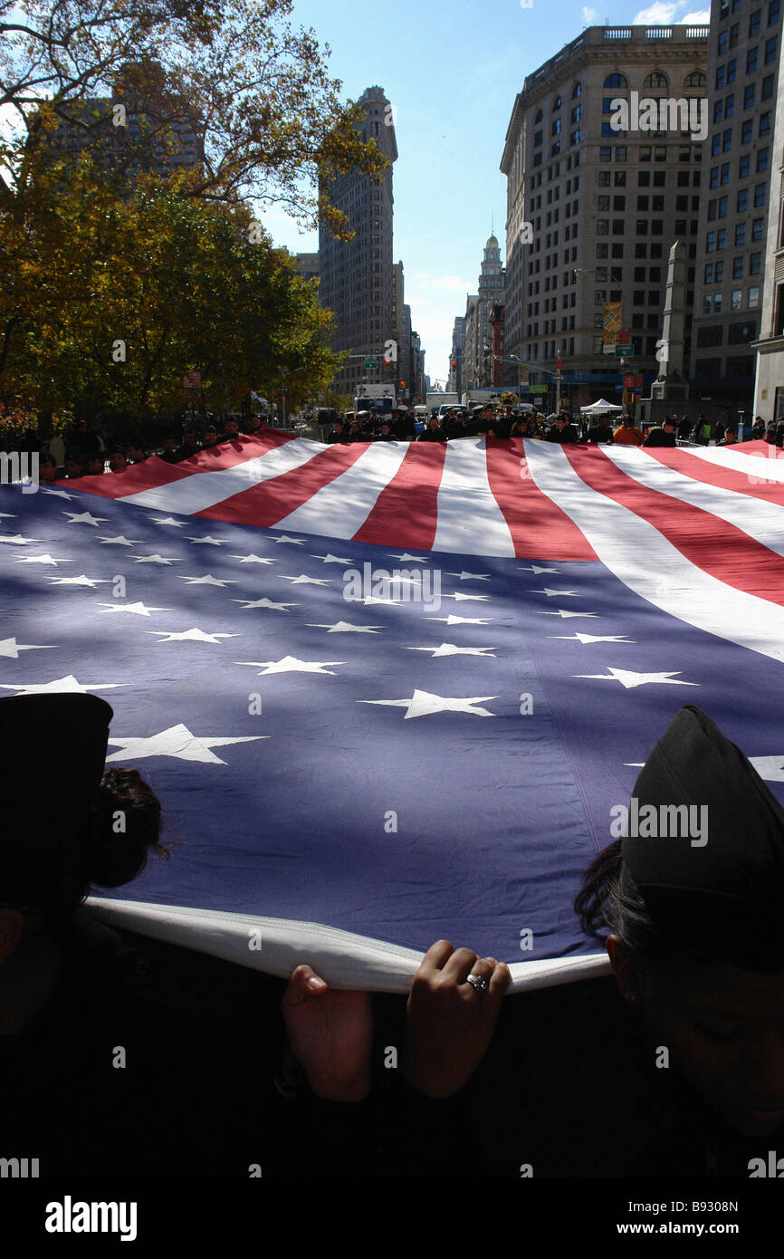 Large USA America flag being carried by many people at Veterans Day ...