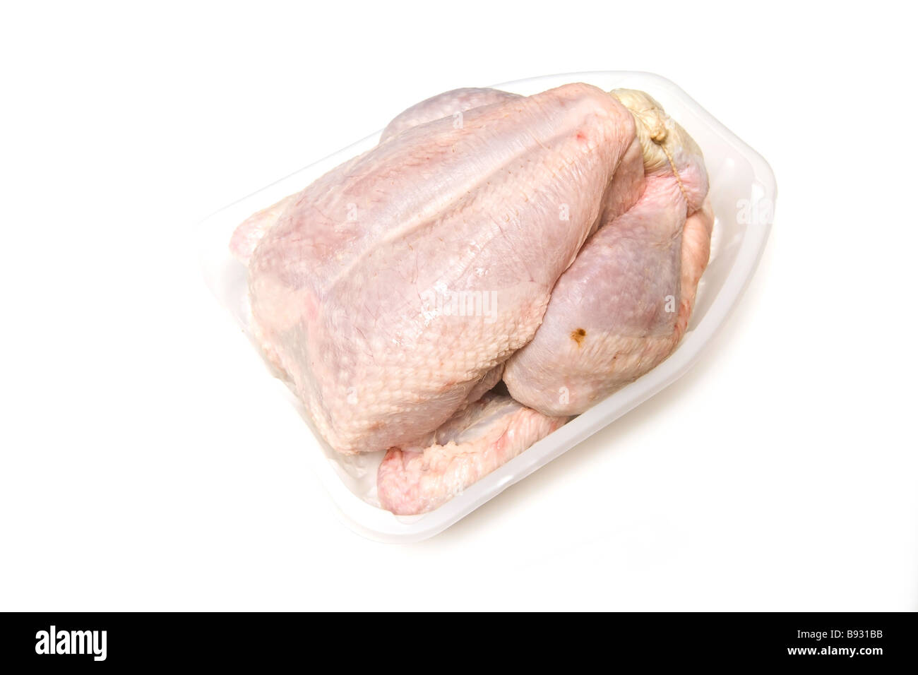 Whole raw chicken isolated on a white studio background Stock Photo - Alamy