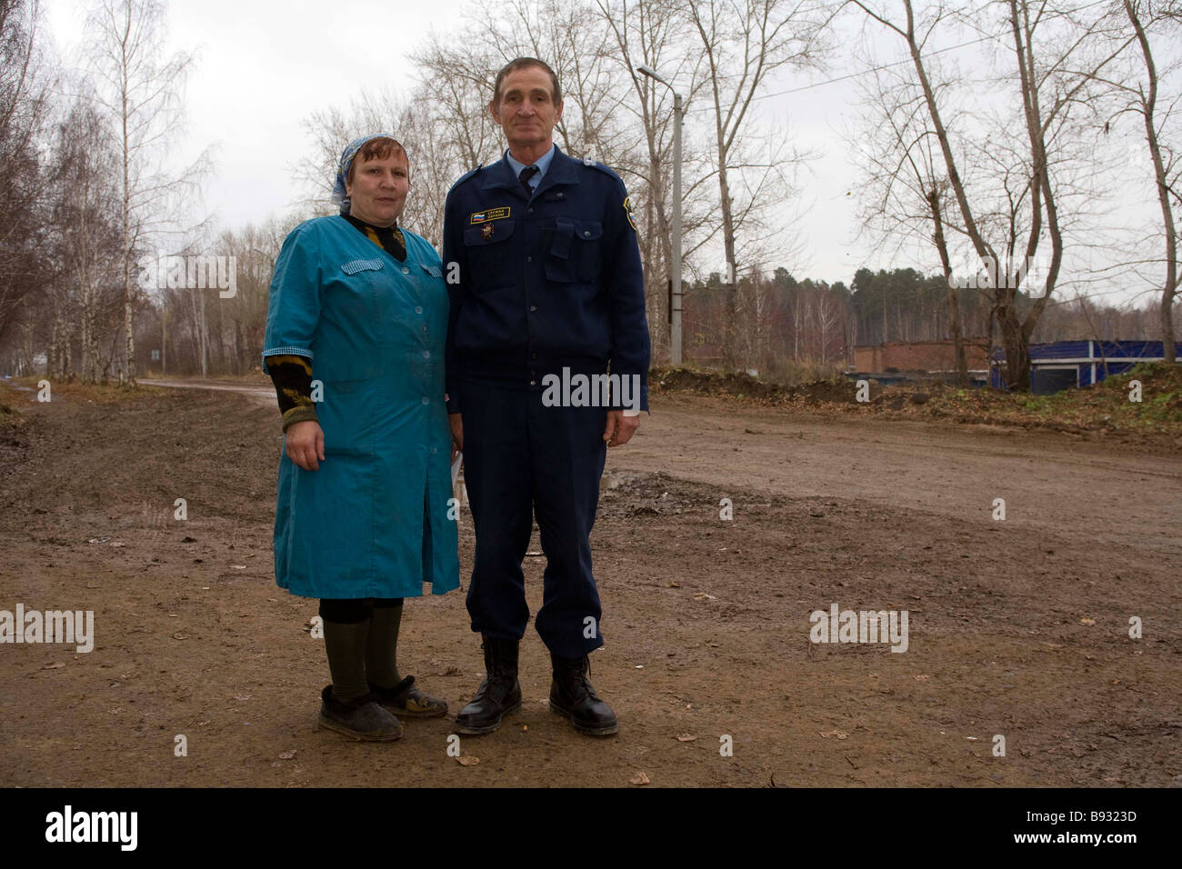Security guard and female colleague at empty industrial site, portrait ...