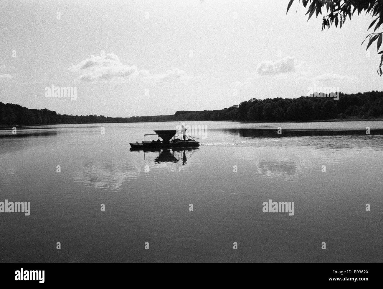 Fish get fodder from this catamaran in a Ukrainian pond Stock Photo - Alamy