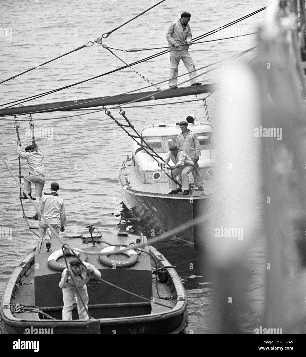 The Navy men learn to climb aboard a warship from a rescue boat using ...