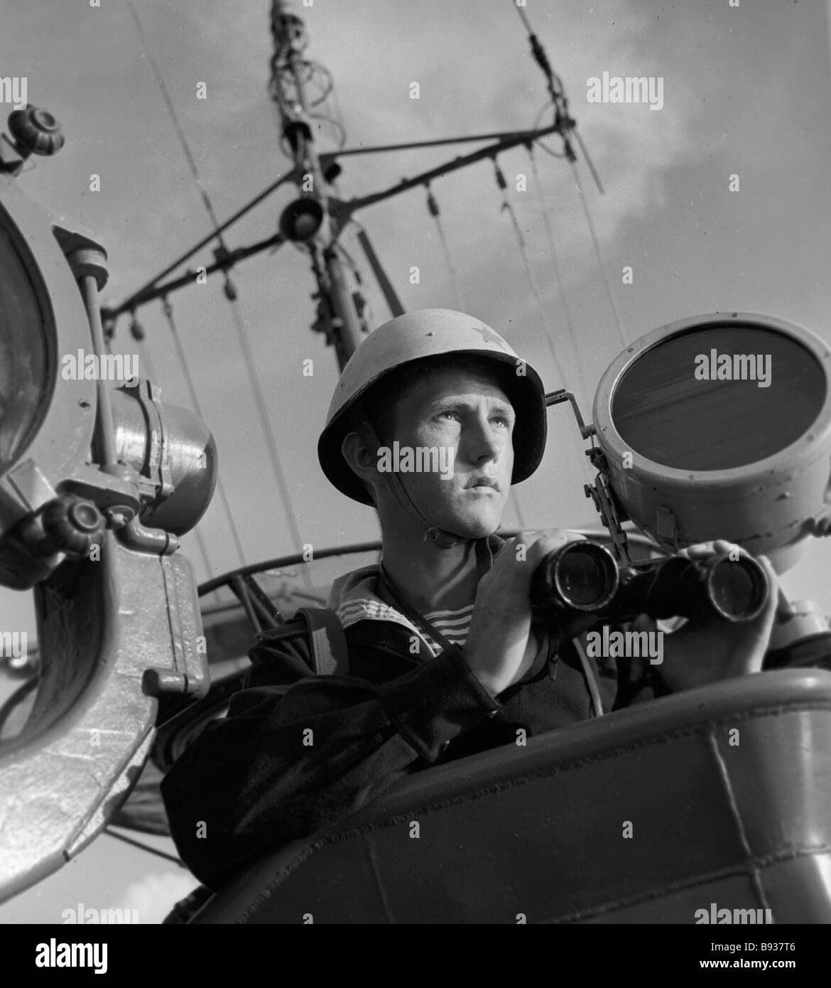 A naval border guard on the deck with binoculars Stock Photo - Alamy