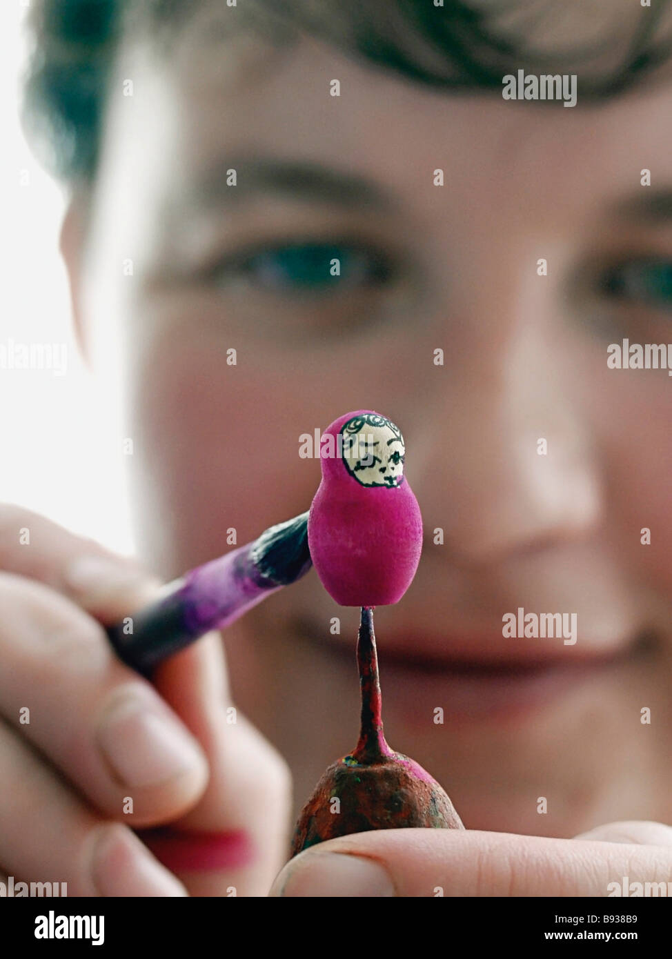 An artist painting a matryoshka nested doll at a private factory in the ...