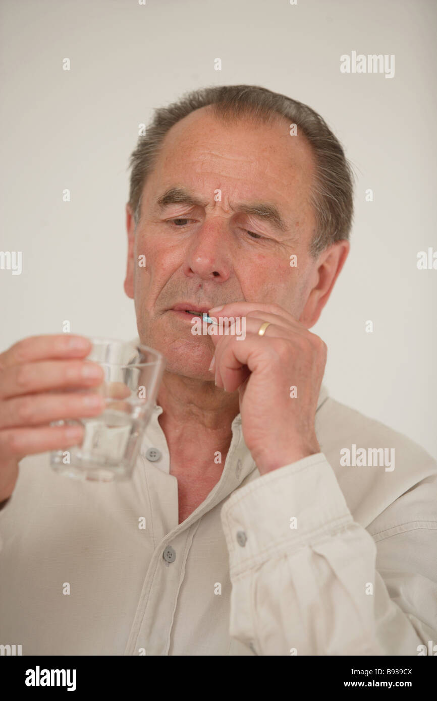Mature Man Taking a Pill Stock Photo - Alamy