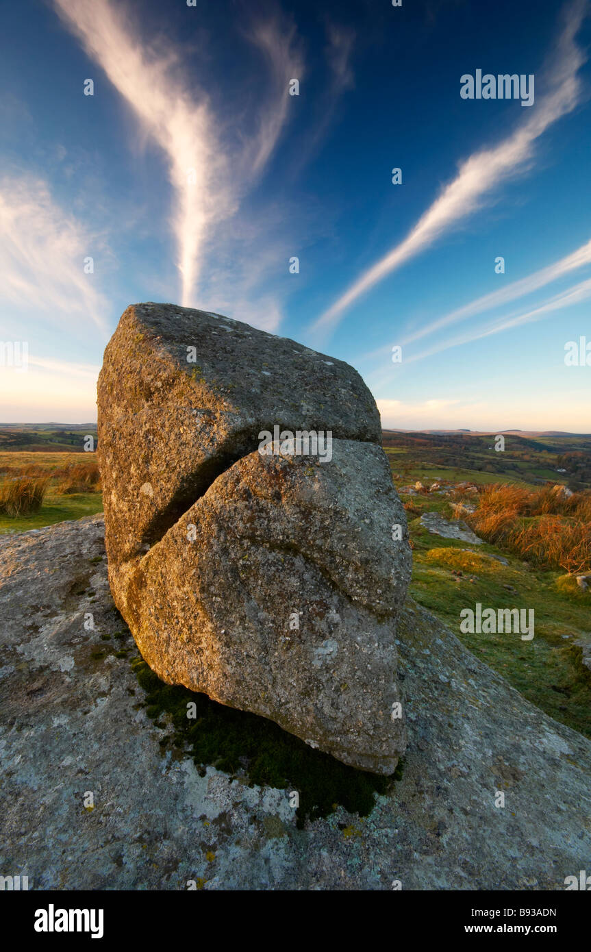 Split granite rock on Combestone Tor backed by mares tails cloud ...