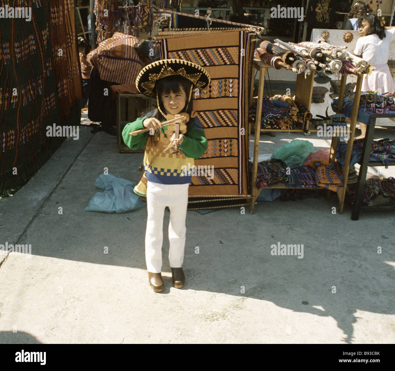 Child playing a small fiddle in a Mexican town Stock Photo - Alamy