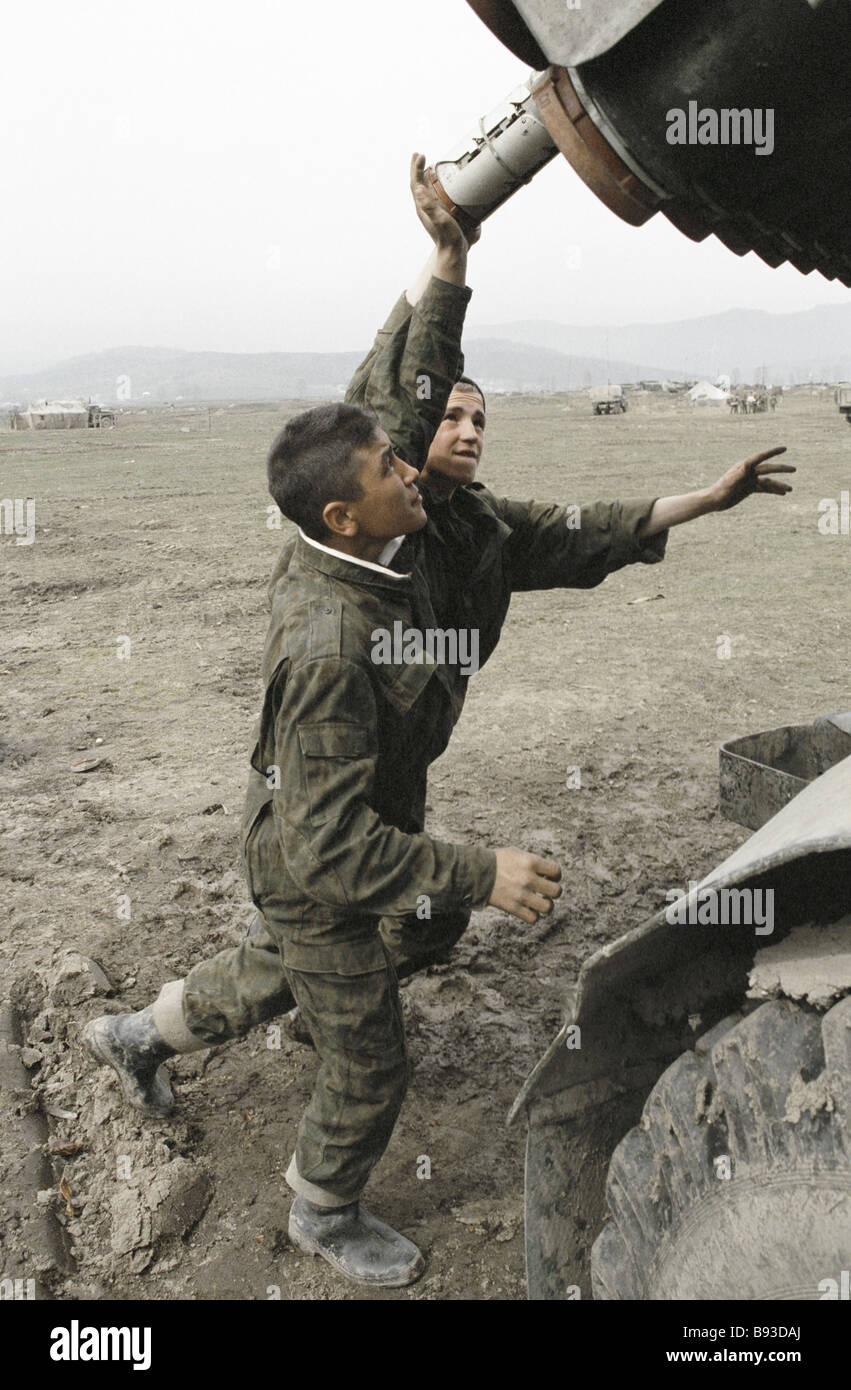 A crew loading rockets into a Grad MLRS vehicle Stock Photo - Alamy