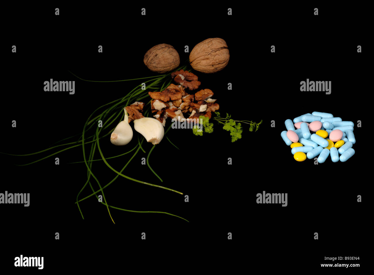 Healthy ingredients and pills on a black background Stock Photo - Alamy