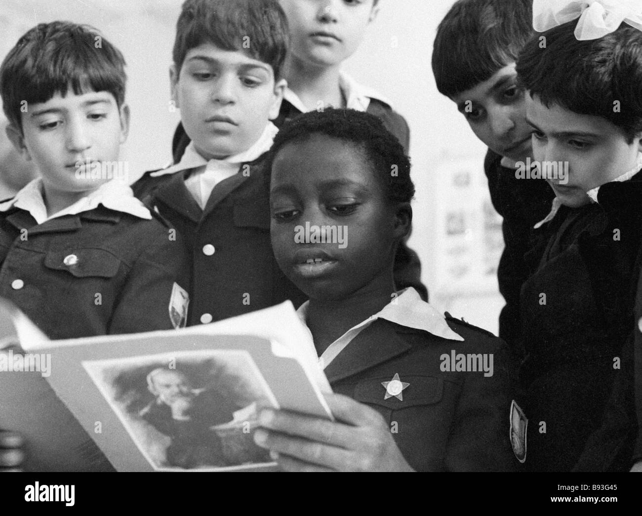 Children read a book about Lenin at the Yelena Stasova International ...