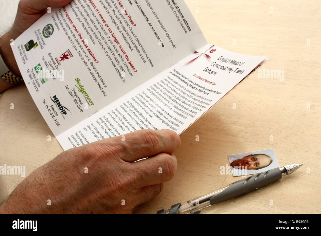 Man reading Leaflet for Bus Pass Stock Photo - Alamy