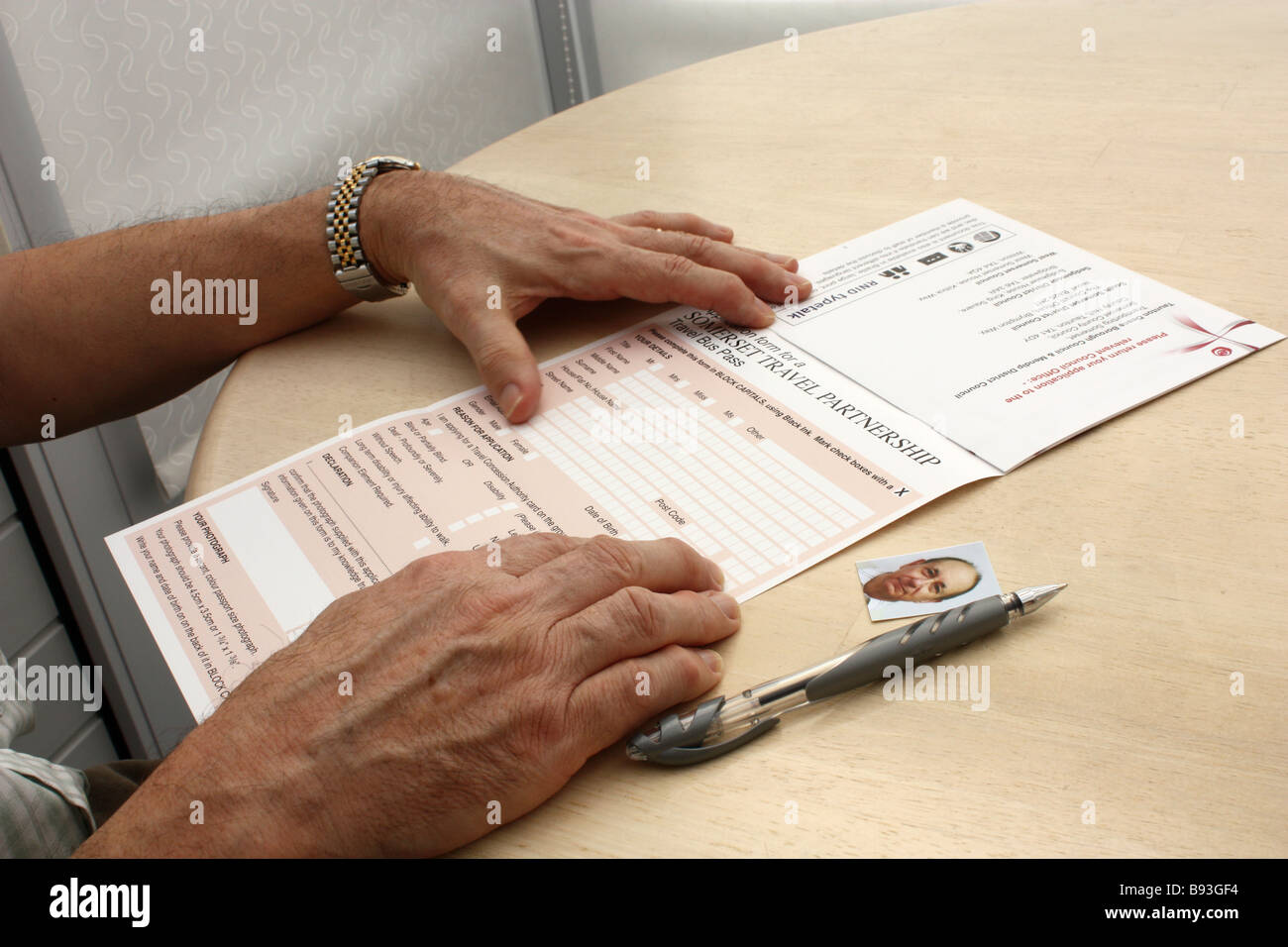 Man Reading a Bus Pass Form Stock Photo - Alamy