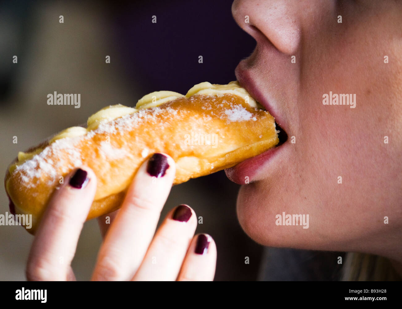 Woman eating a cream cake Stock Photo - Alamy