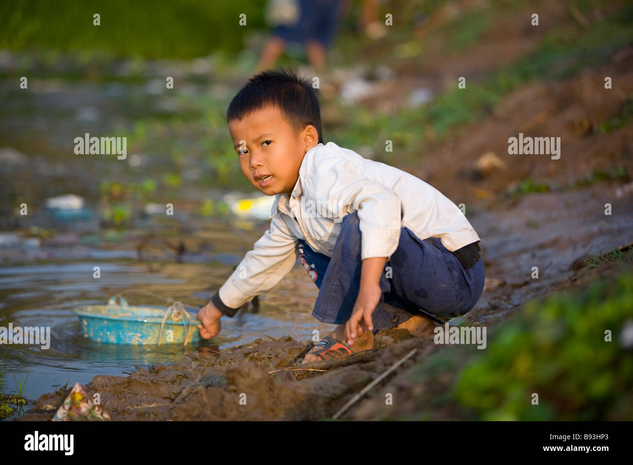 Young child gathering water at Roesey Chroy Secondary School Stock ...