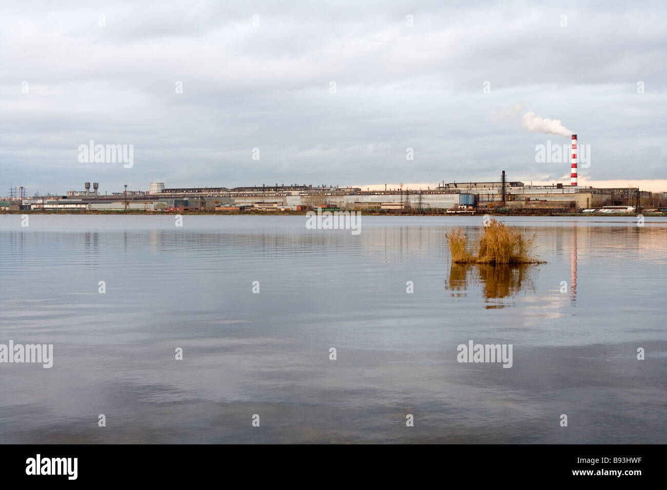 View of lake and industrial skyline with smoke stack, Ekaterinburg ...