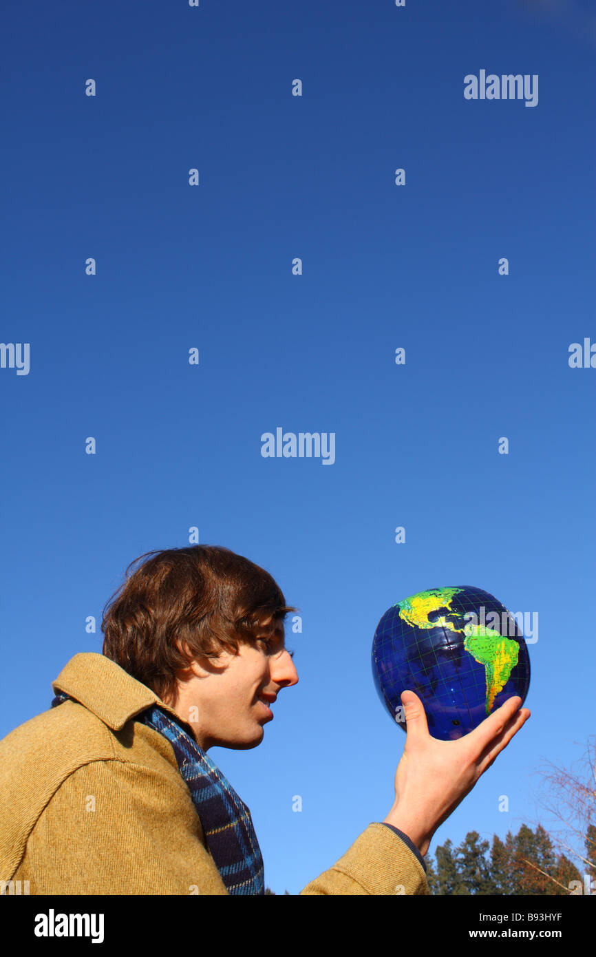 Man holding globe Stock Photo - Alamy