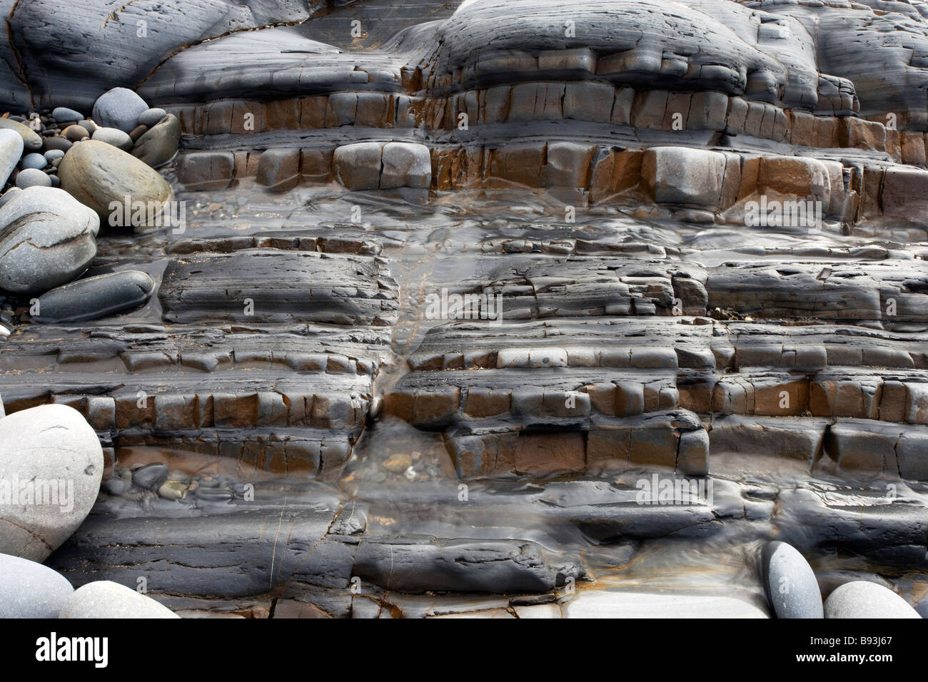 Close up of grey rock strata on the coastal cliffs at Sandymouth, North ...