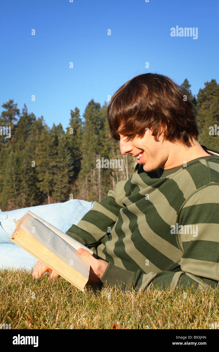 Man Reading Book Outdoors Stock Photo - Alamy