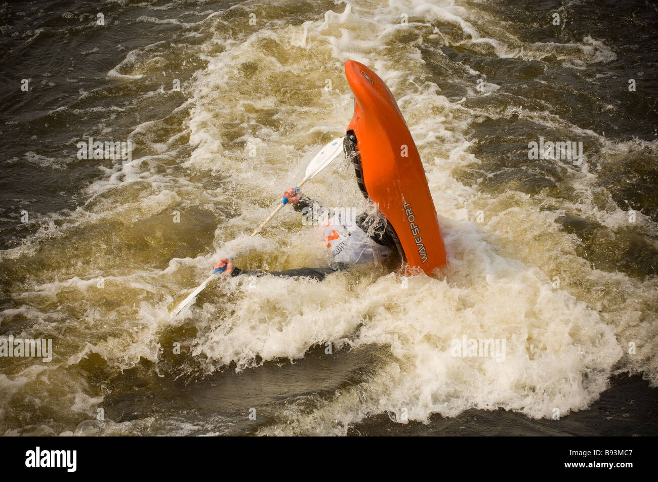 Kayaker with their head and the stern of the kayak submerged in white ...