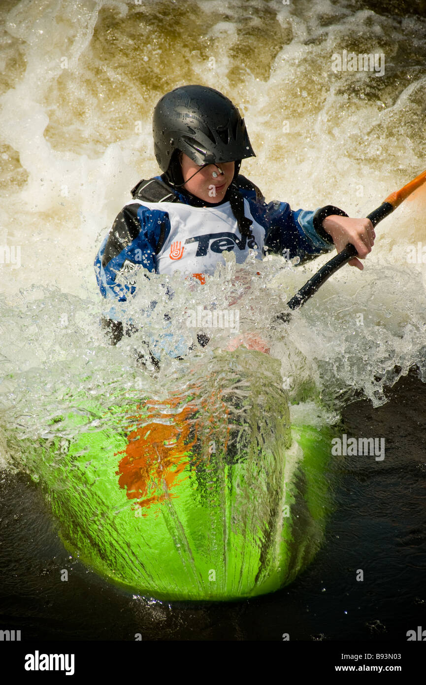 Young caucasian male kayaker performing trick in white water at Tees ...
