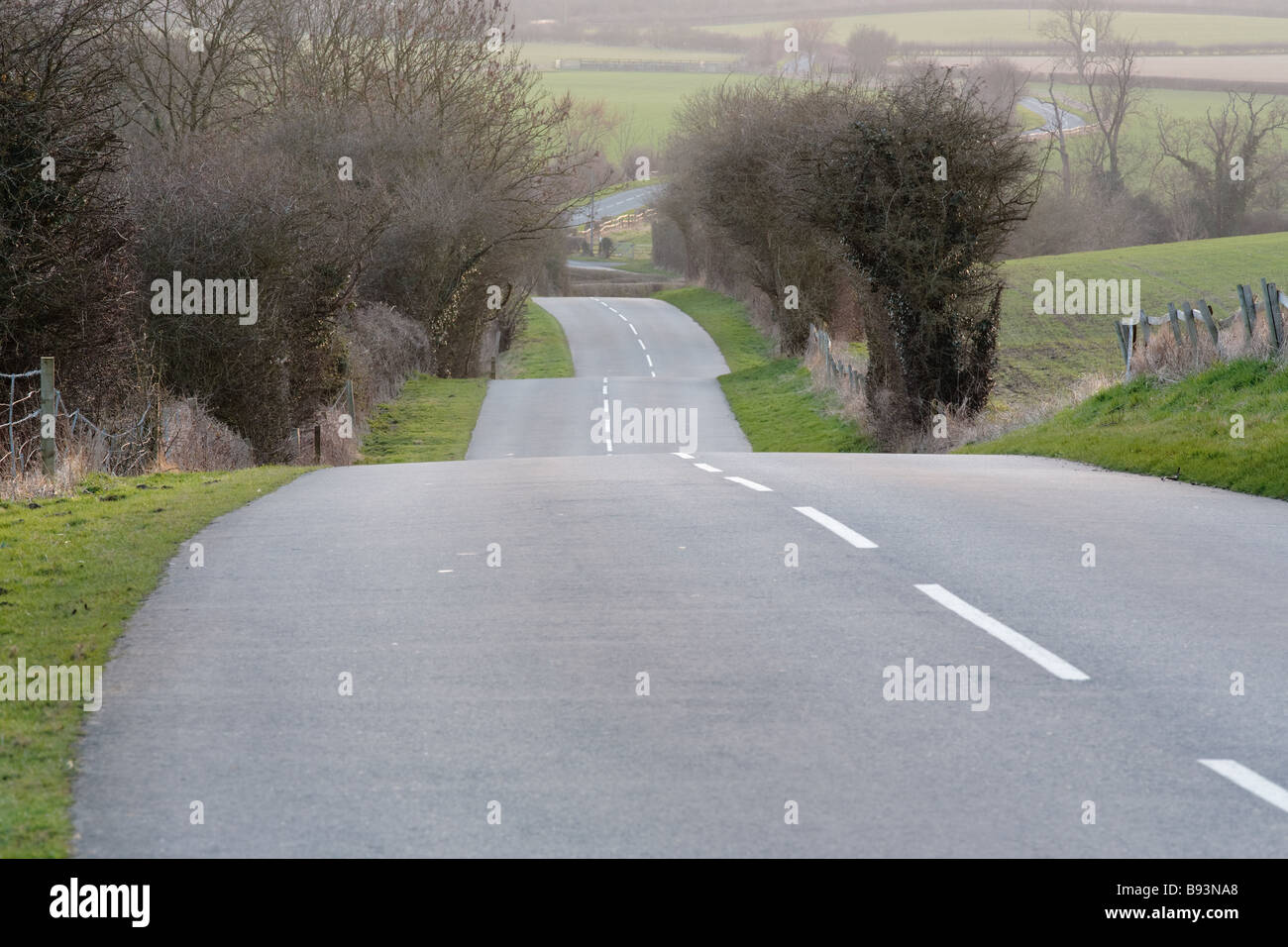 A rural road dips and undulates through the English countryside Stock ...