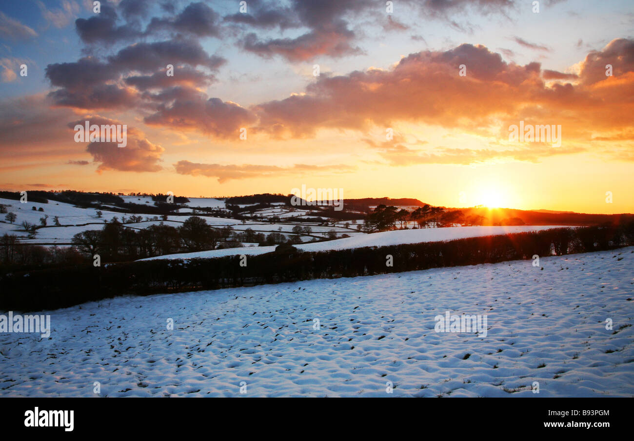 Sunset over the winter landscape of the Dorset Downs near the village ...