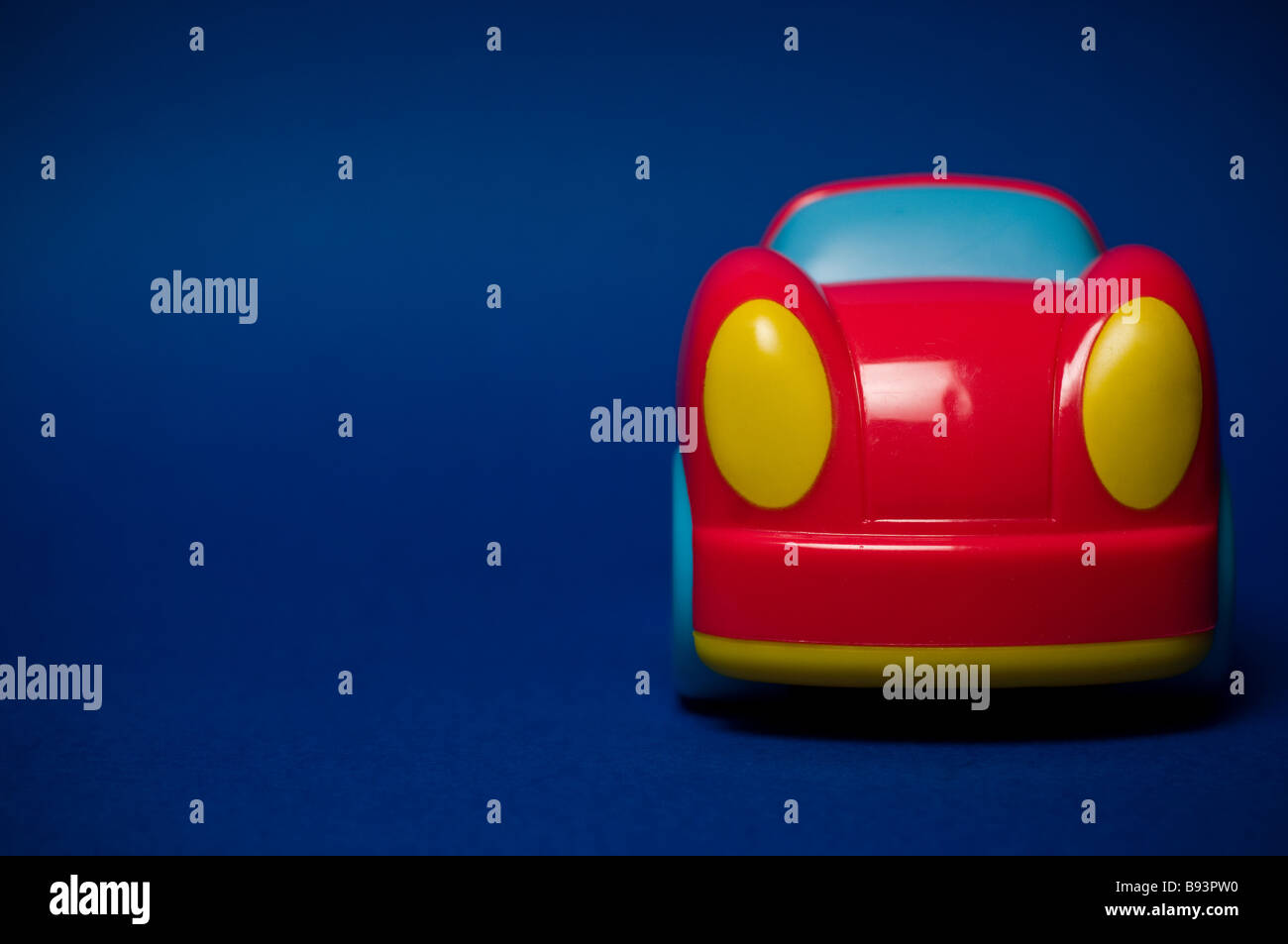 A child's red toy car on a blue background Stock Photo - Alamy