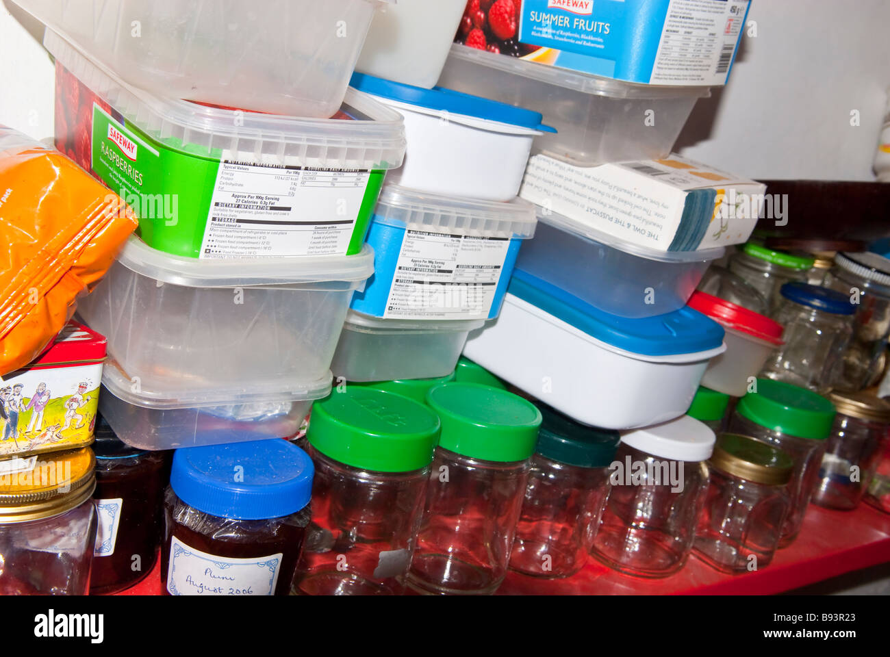 A cluttered untidy larder pantry housing lots of jars and empty food ...