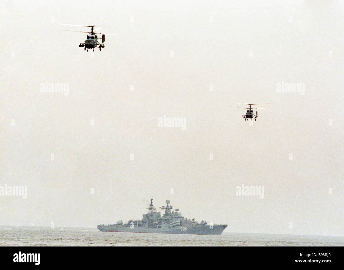 Helicopters fly over a Pacific Fleet warship in the open sea during ...