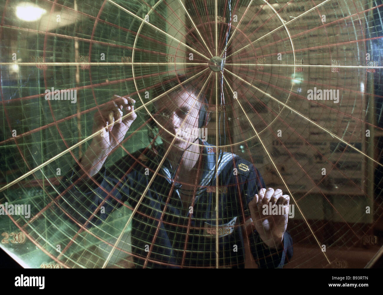 A map bag sailor putting marks on a map during a Pacific Fleet military ...