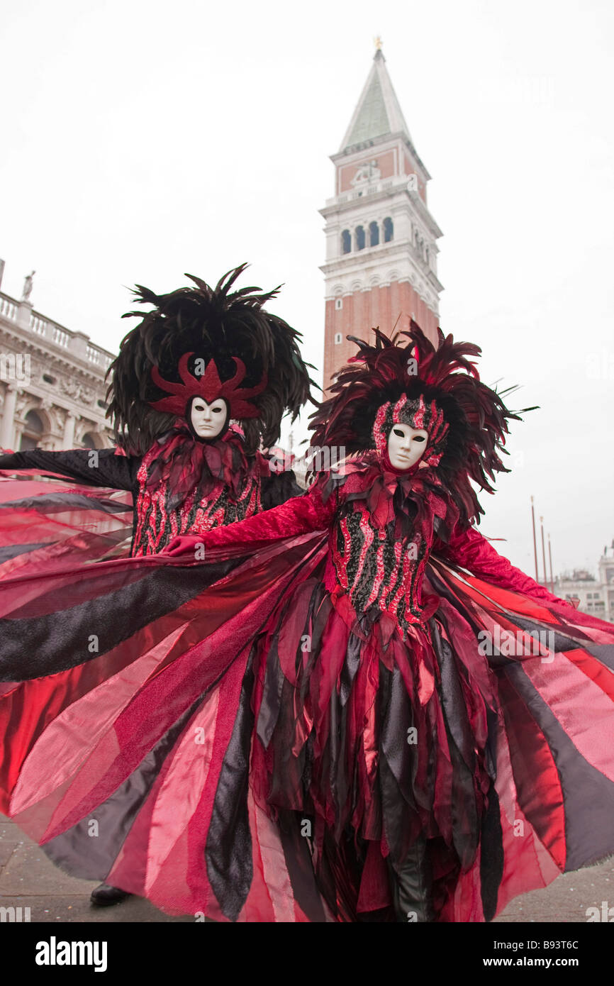 Venice Carnival. 2 characters red pink hat Costume & mask feathers San Marco. Venice Veneto ...