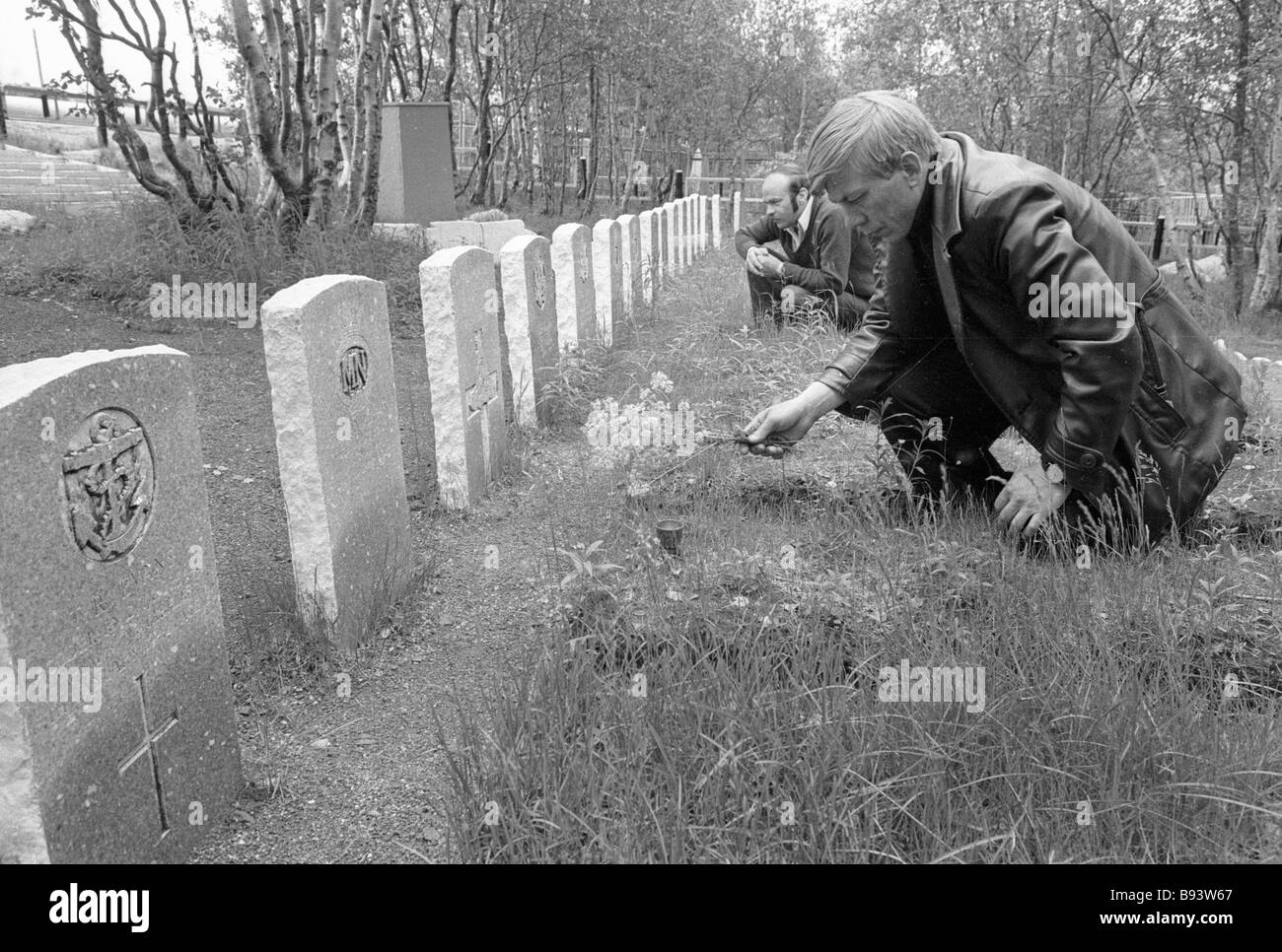 Relatives at graves at the allied military cemetery in Murmansk Soviet ...
