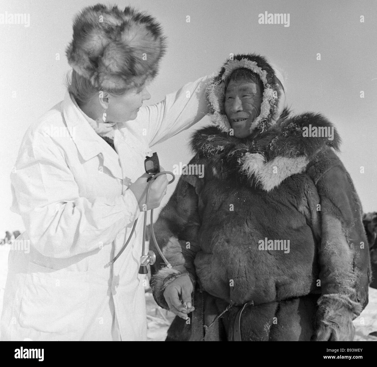 A doctor checks blood pressure of a reindeer breeder in tundra Stock ...