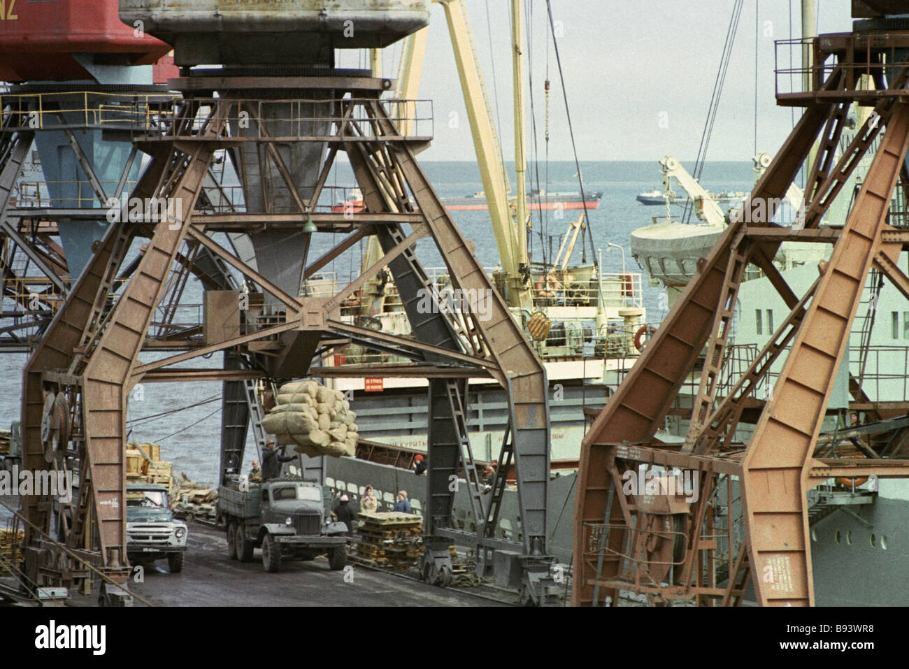 Ships are loaded and unloaded at the freight docks of the port of Tiksi ...