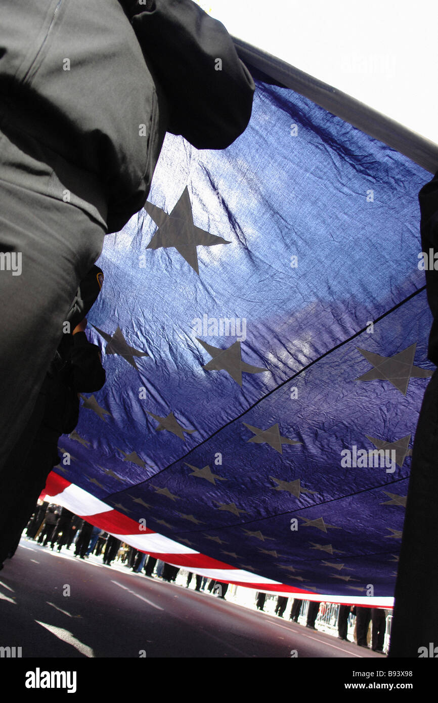 Large USA America flag being carried by many people at Veterans Day ...