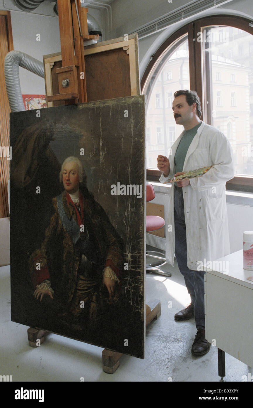 Restorer painter Andrei Golubenko working in the restoration workshop ...