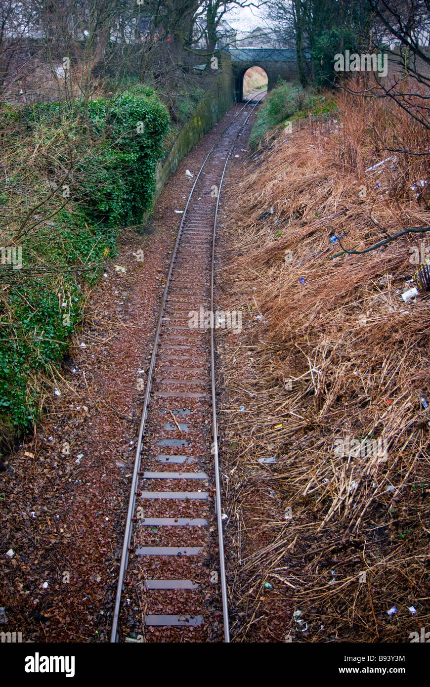 photograph of rubbish strewn railway track and bridge Stock Photo - Alamy