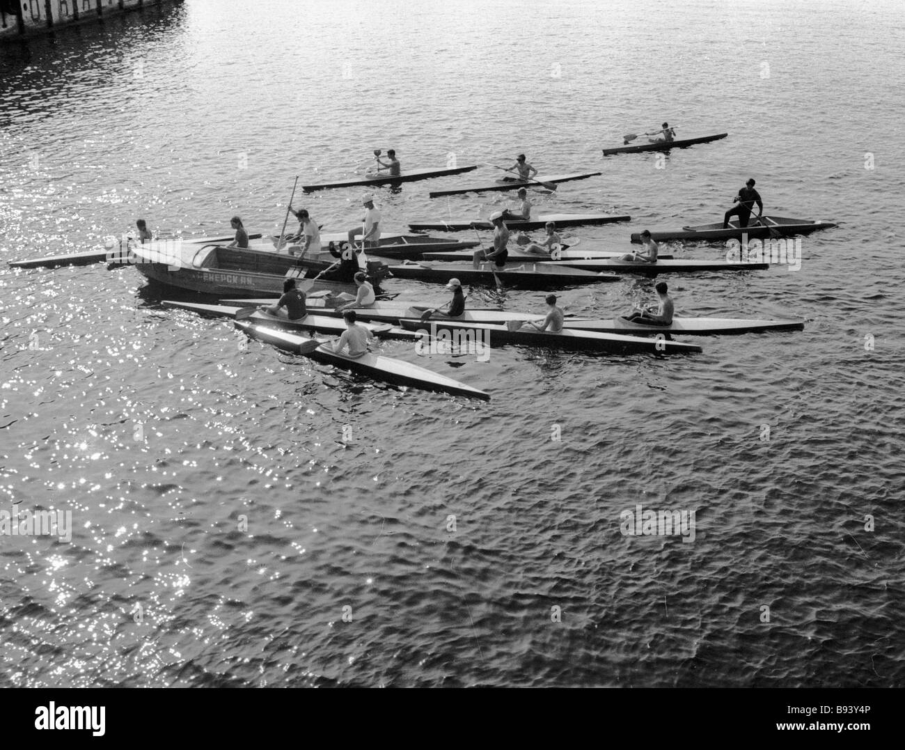 Coach of rowing school for children and teenagers instructs his ...