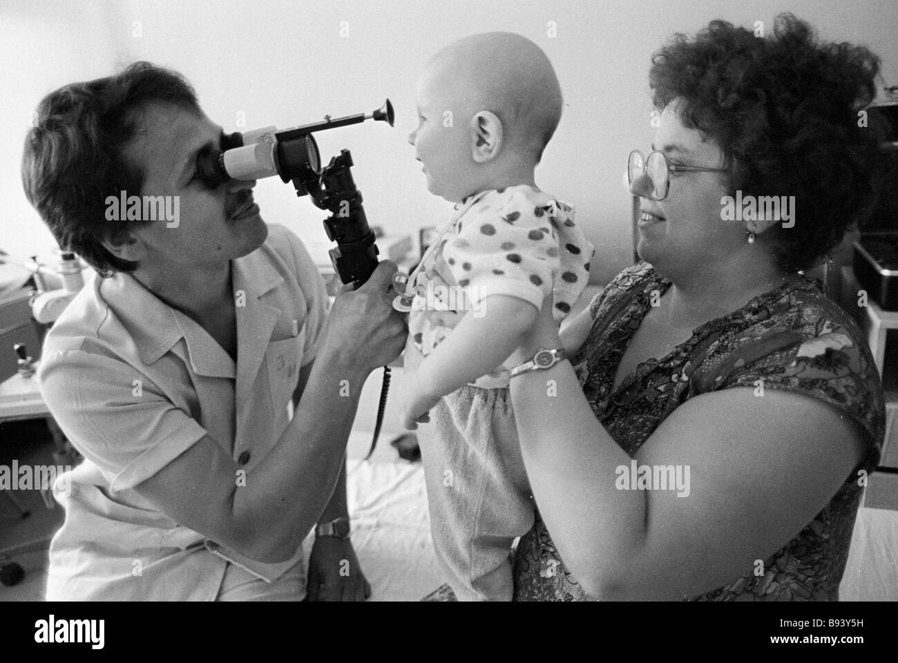 A doctor with the Ufa Research Institute of Eye Diseases curing a young ...