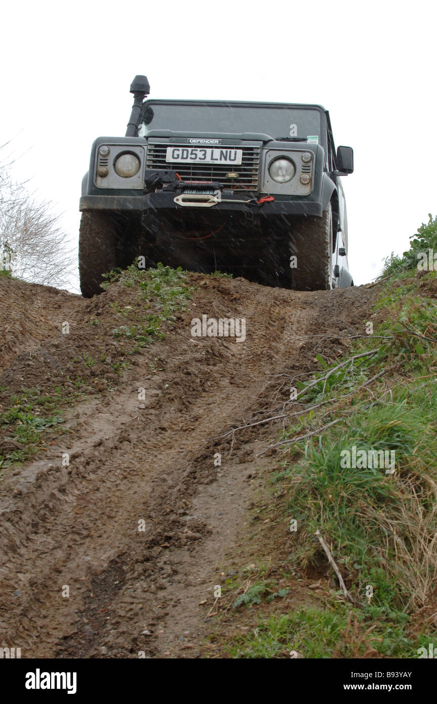 Land Rover Defender 4x4 crests steep hill mud track Stock Photo - Alamy