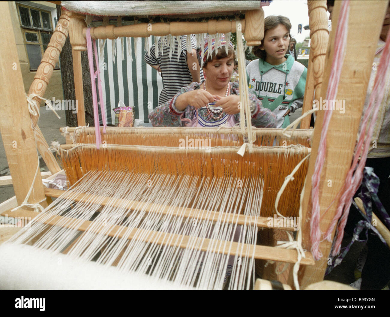 A weaver working at the Fair of Folk Crafts on the 1000th anniversary ...