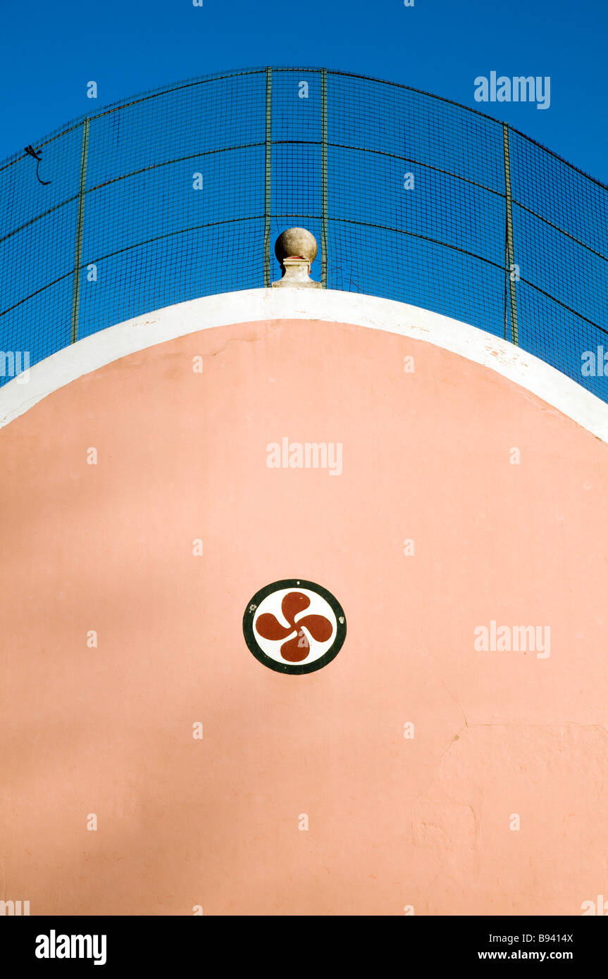 Basque cross painted on the " fronton" of the village Pelote court ...