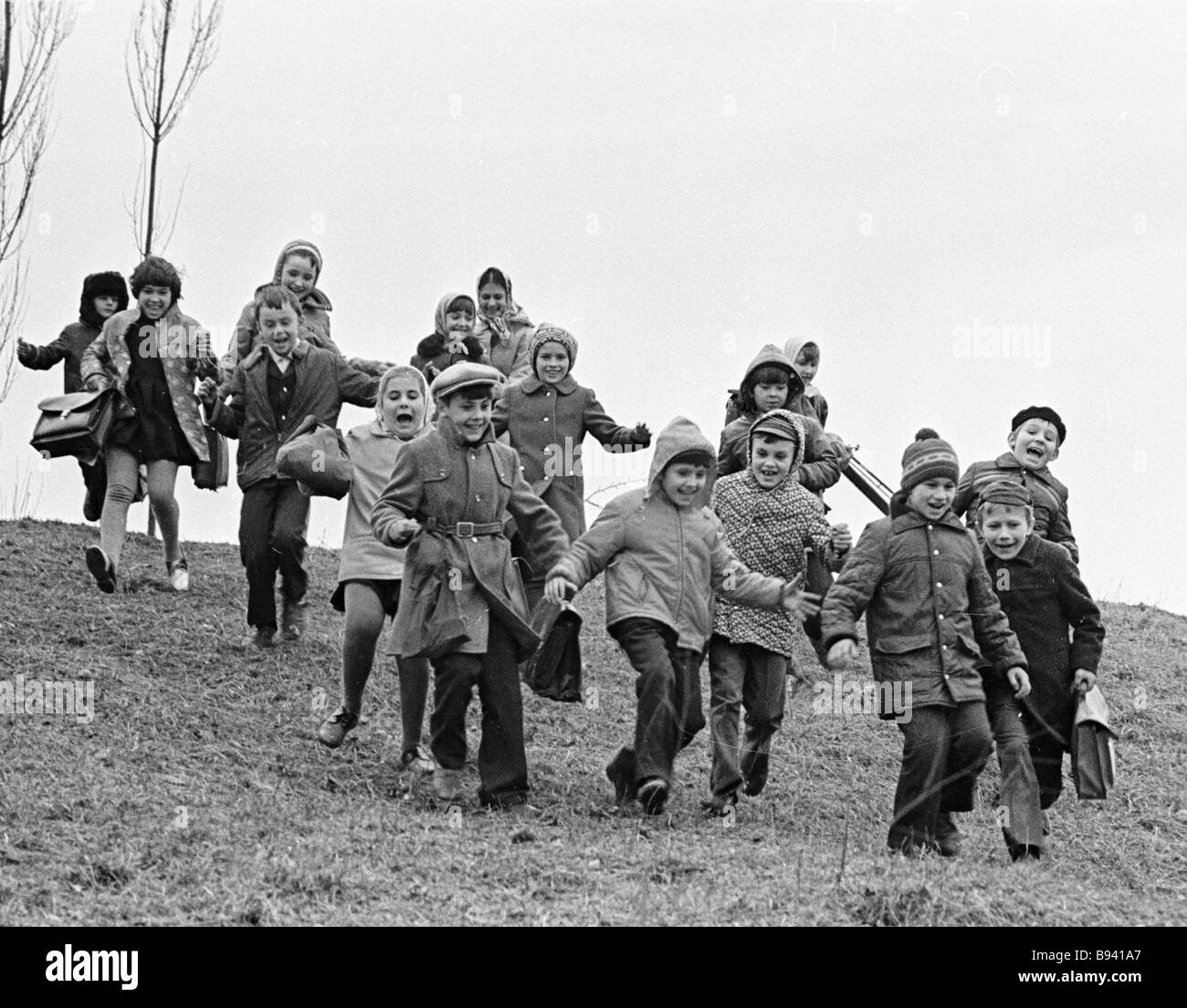 Schoolchildren running home after classes Stock Photo - Alamy