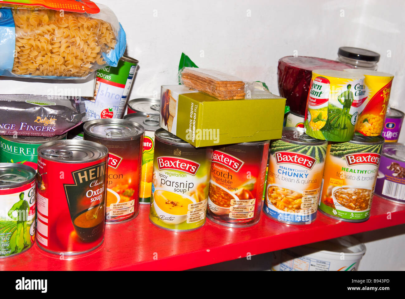 A cluttered untidy larder pantry housing lots of tins of food Stock ...