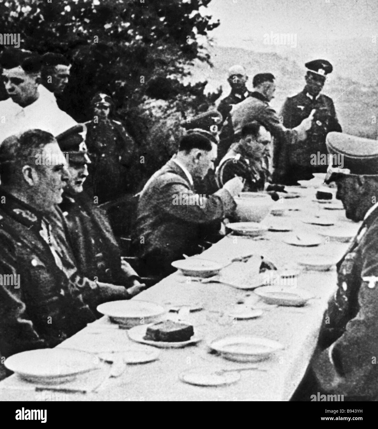 Adolf Hitler center and his company having dinner Stock Photo - Alamy