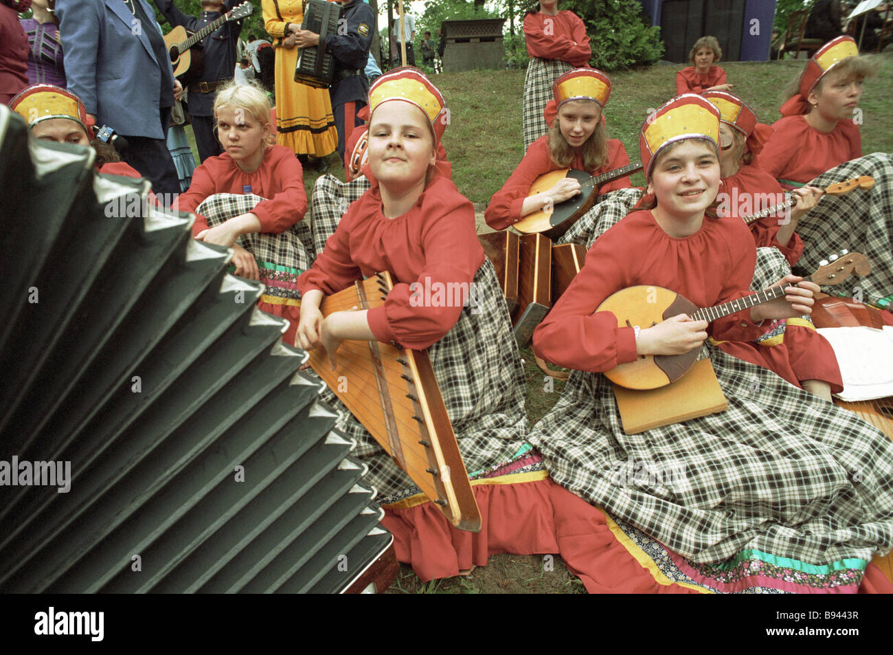 Young members of a folklore ensemble play folk musical instruments ...