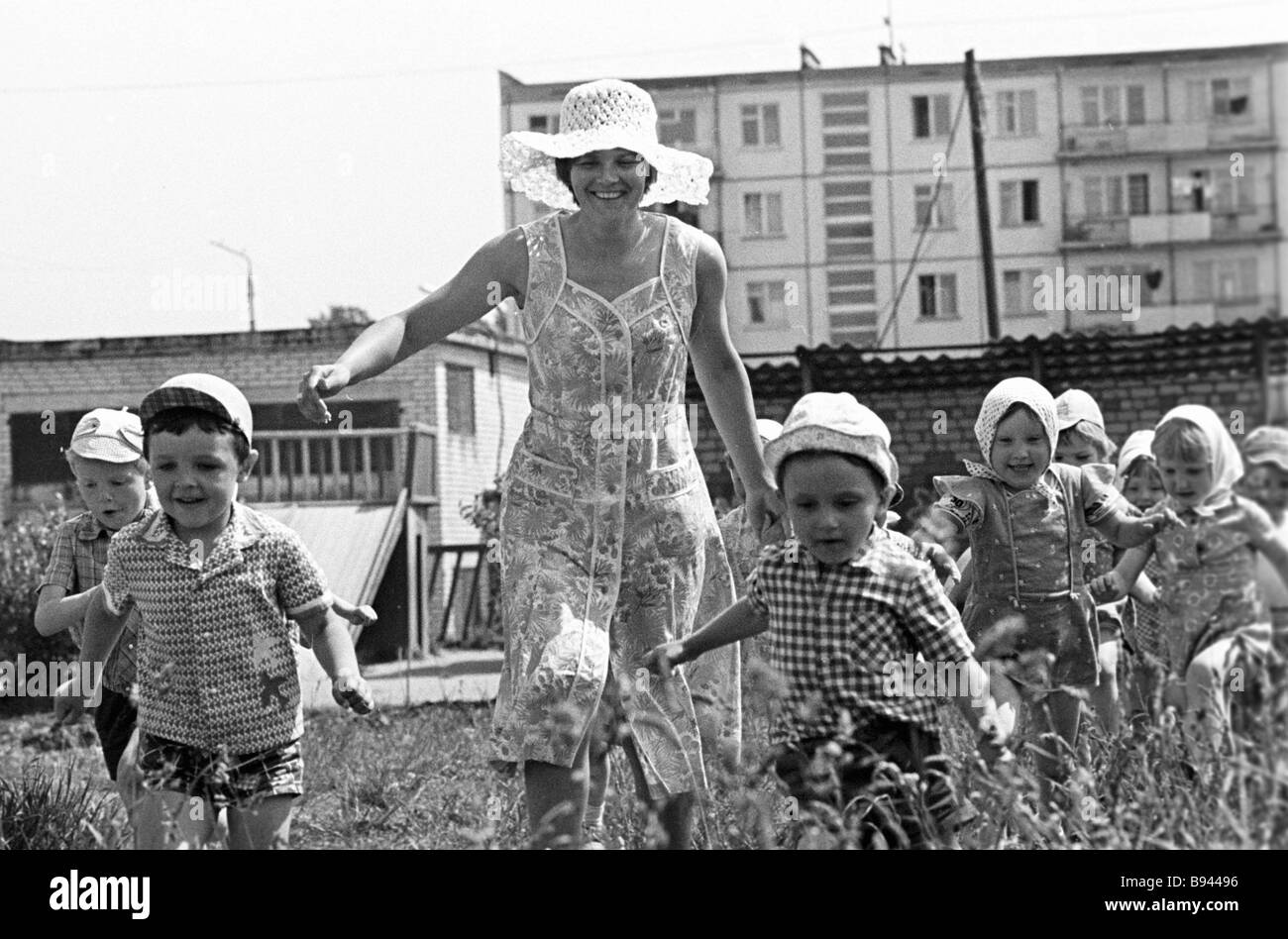 Children walk with their teacher Novgorodsky state farm kindergarten ...