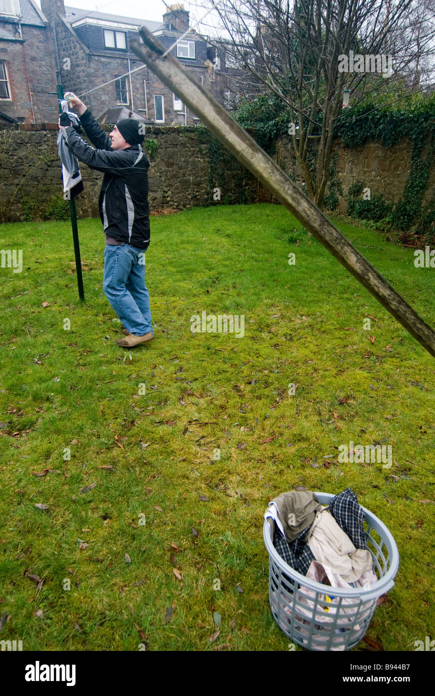 photograph of man hanging up laundry outside Stock Photo - Alamy