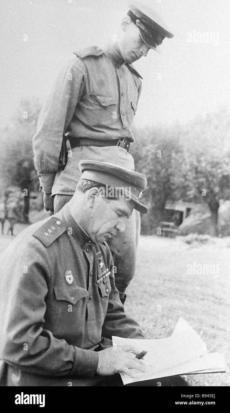 Vasily Chuikov commander of the Eighth Guards Army sitting reads report ...