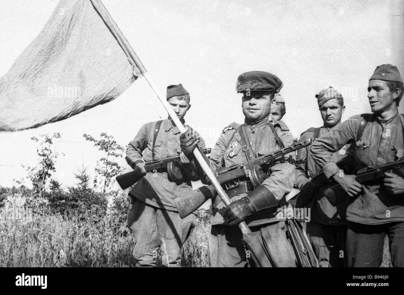 Hero of the Soviet Union V P Zaitsev second from left crossing banner ...