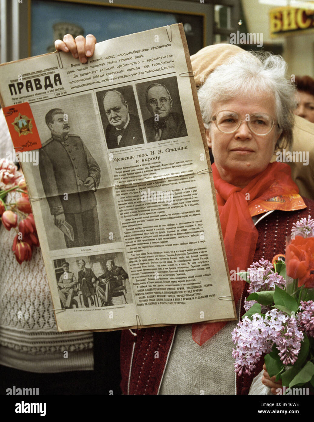 A Muscovite shows an old Pravda daily with Josef Stalin portrait V Day ...